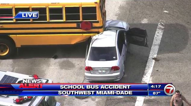 Car stuck underneath school bus after collision, students safe - WSVN ...