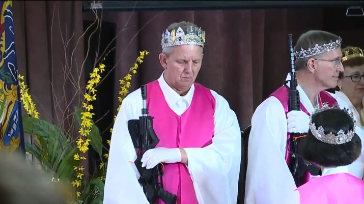 Worshippers clutching AR-15 rifles attend blessing ceremony at ...