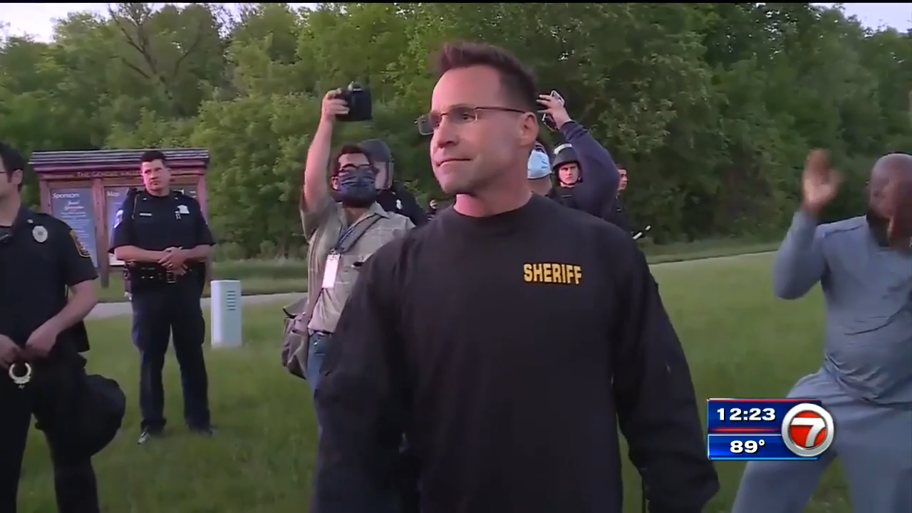A sheriff put down his baton to listen to protesters. They chanted ...