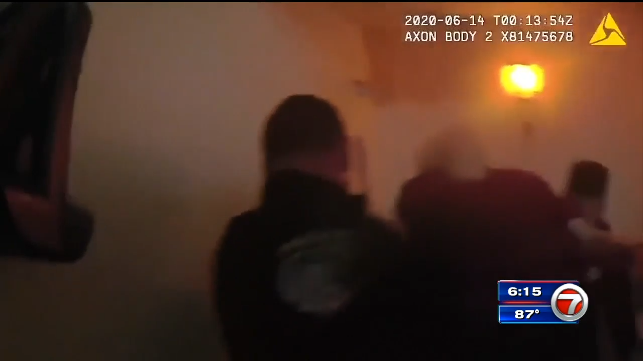 Coral Springs Police officers carry woman downstairs after condo ...