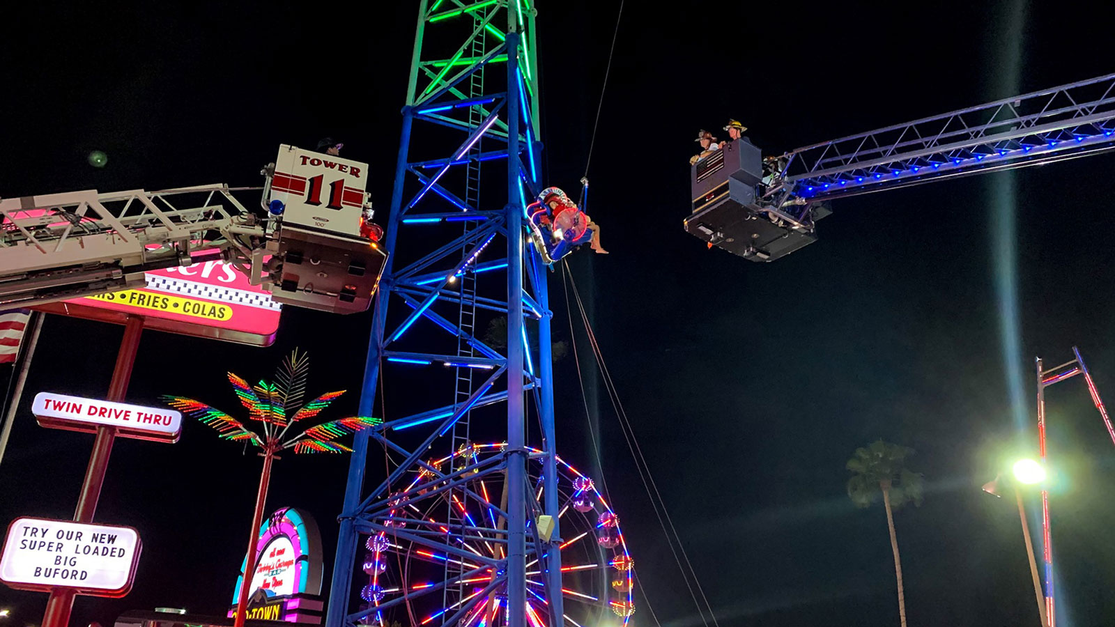 Two teens were suspended for hours on a broken amusement park ride in ...