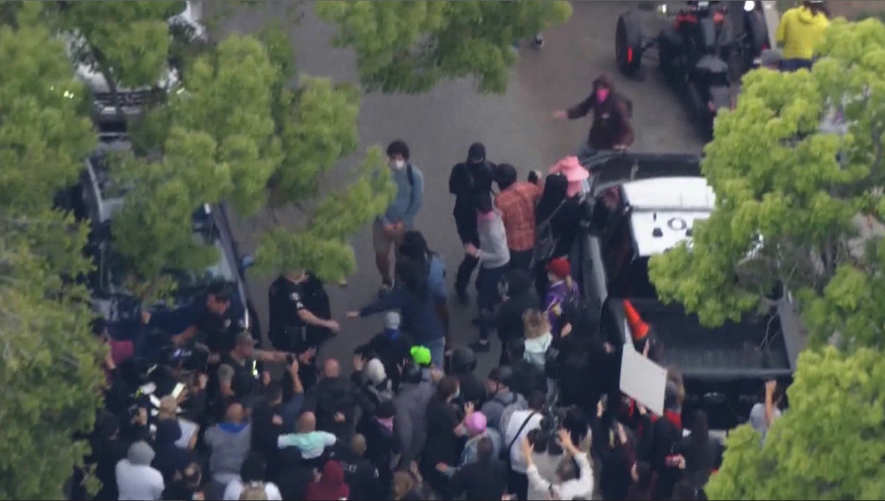Fights break out outside school district meeting as protesters battle ...