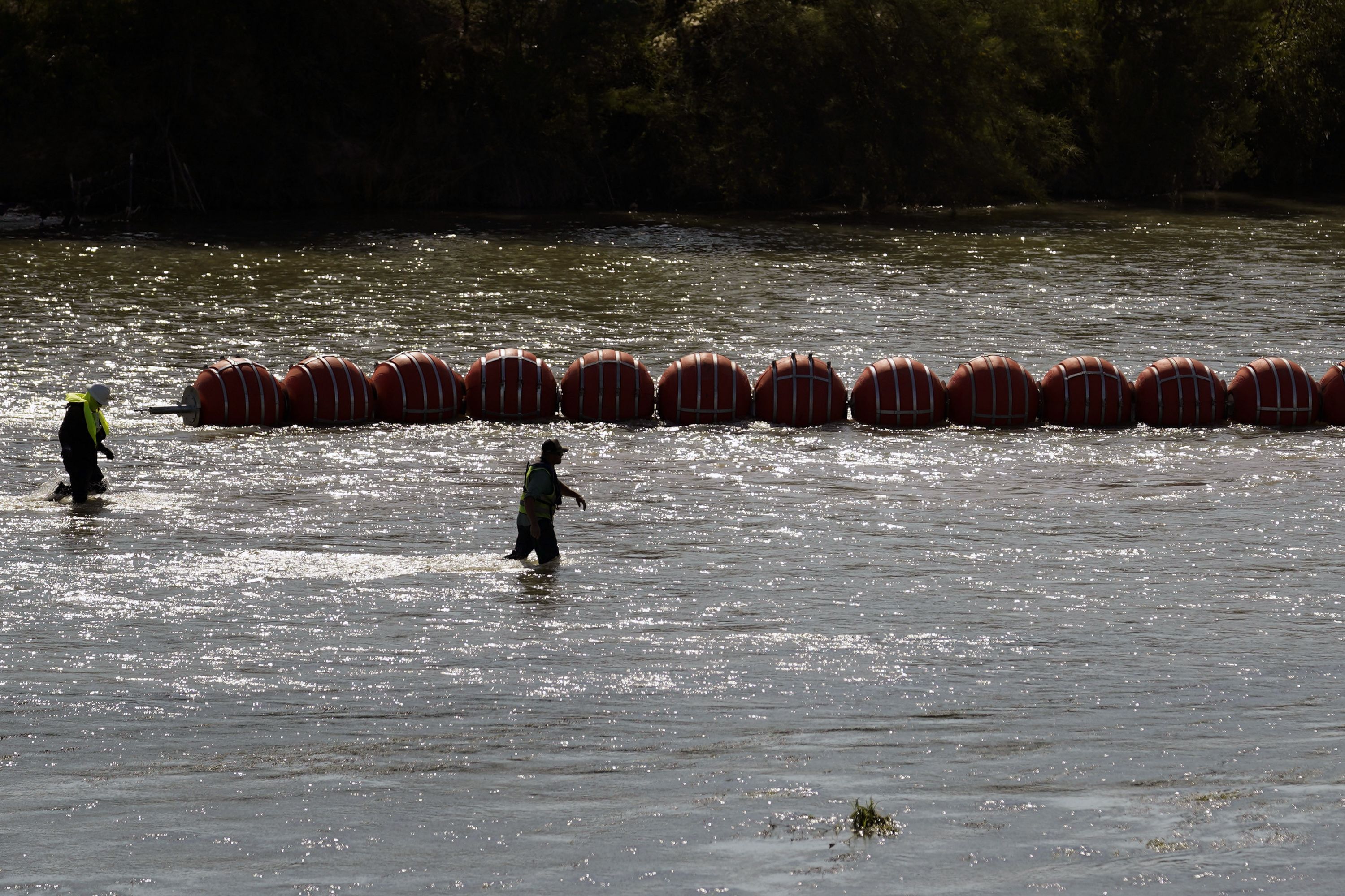 Justice Department sues to force Texas to remove floating barriers in ...