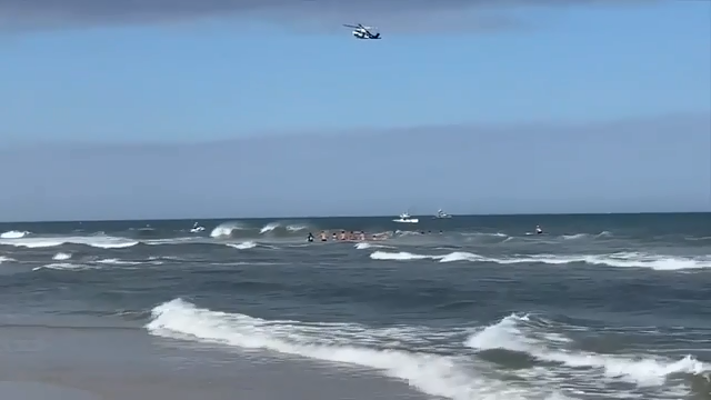 1 person dies and more than a dozen swimmers are rescued after rip current warnings along the ...