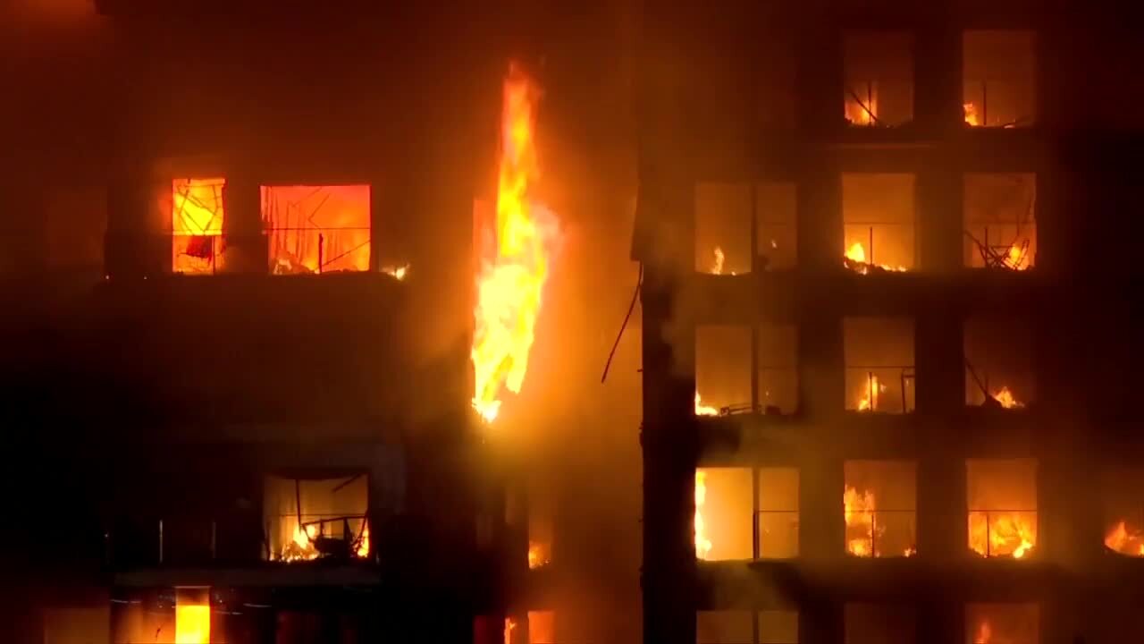 Rescuers search for 14 people missing after apartment block fire in ...
