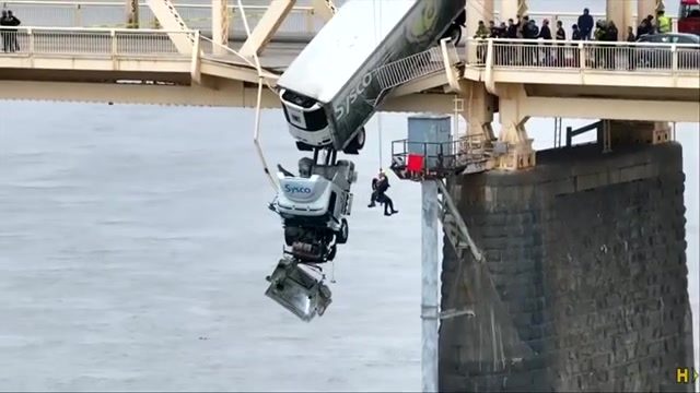 Truck driver pulled to safety after crash leaves vehicle dangling over ...