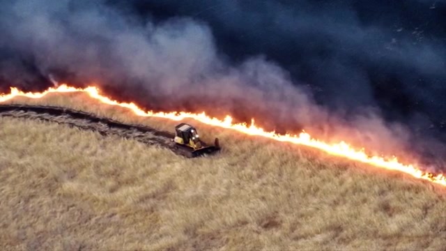 California firefighters continue battling wind-driven wildfire east of ...