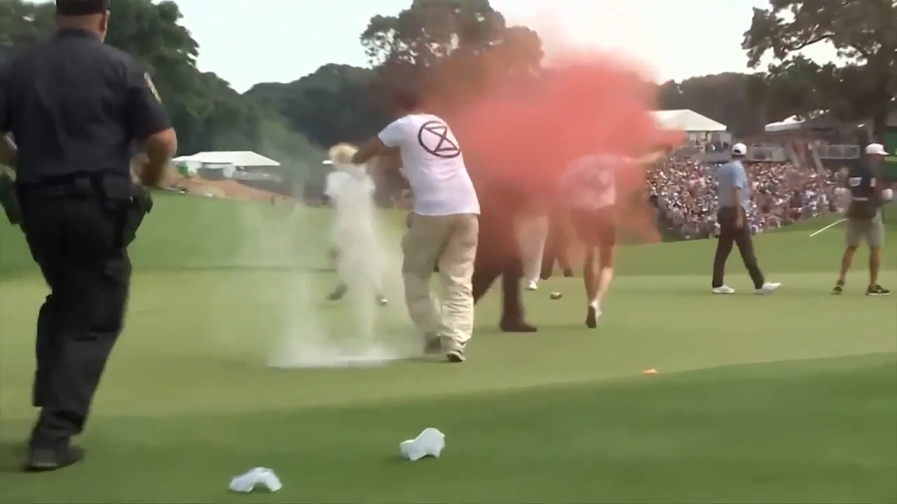 Six climate protesters run onto 18th green and spray powder, delaying ...
