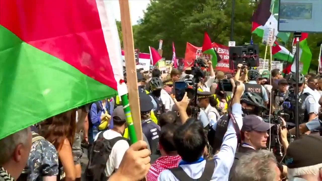 Some protesters tear down security fence as thousands march outside ...