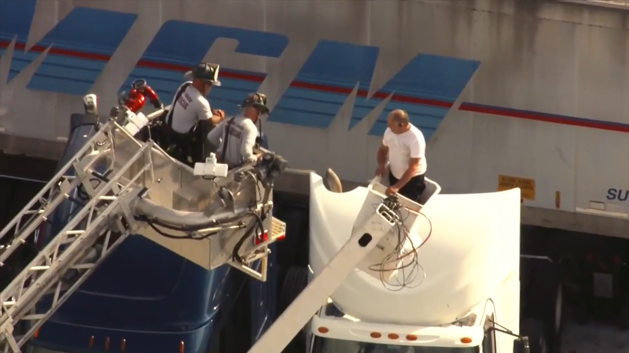 Fire crews help rescue man stuck on the bucket of a boom truck in NW ...