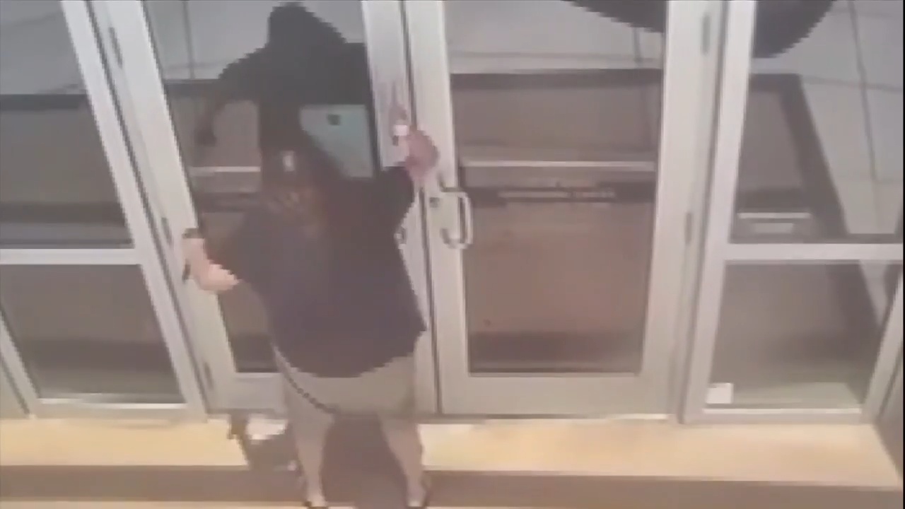 Woman arrested after being seen on video stabbing window, doors of ...