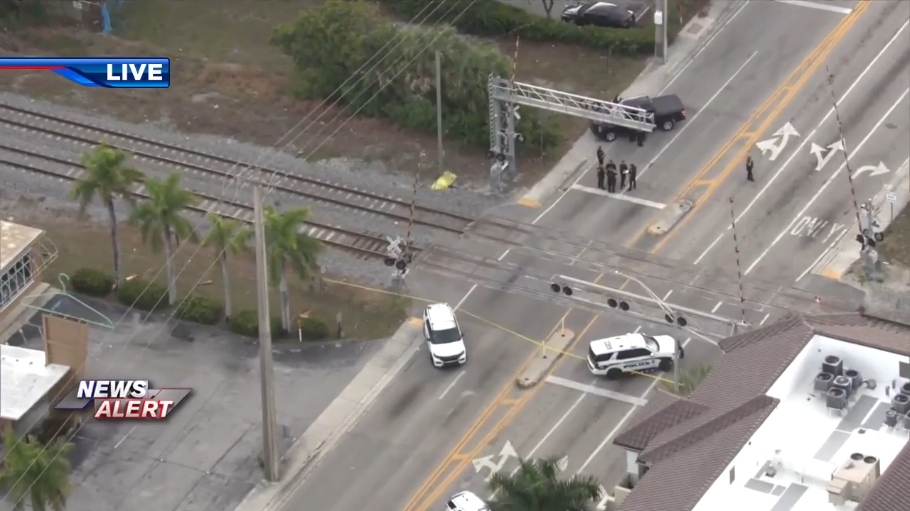 Police shut down railroad crossing near Dixie Highway and NE 26th St in ...